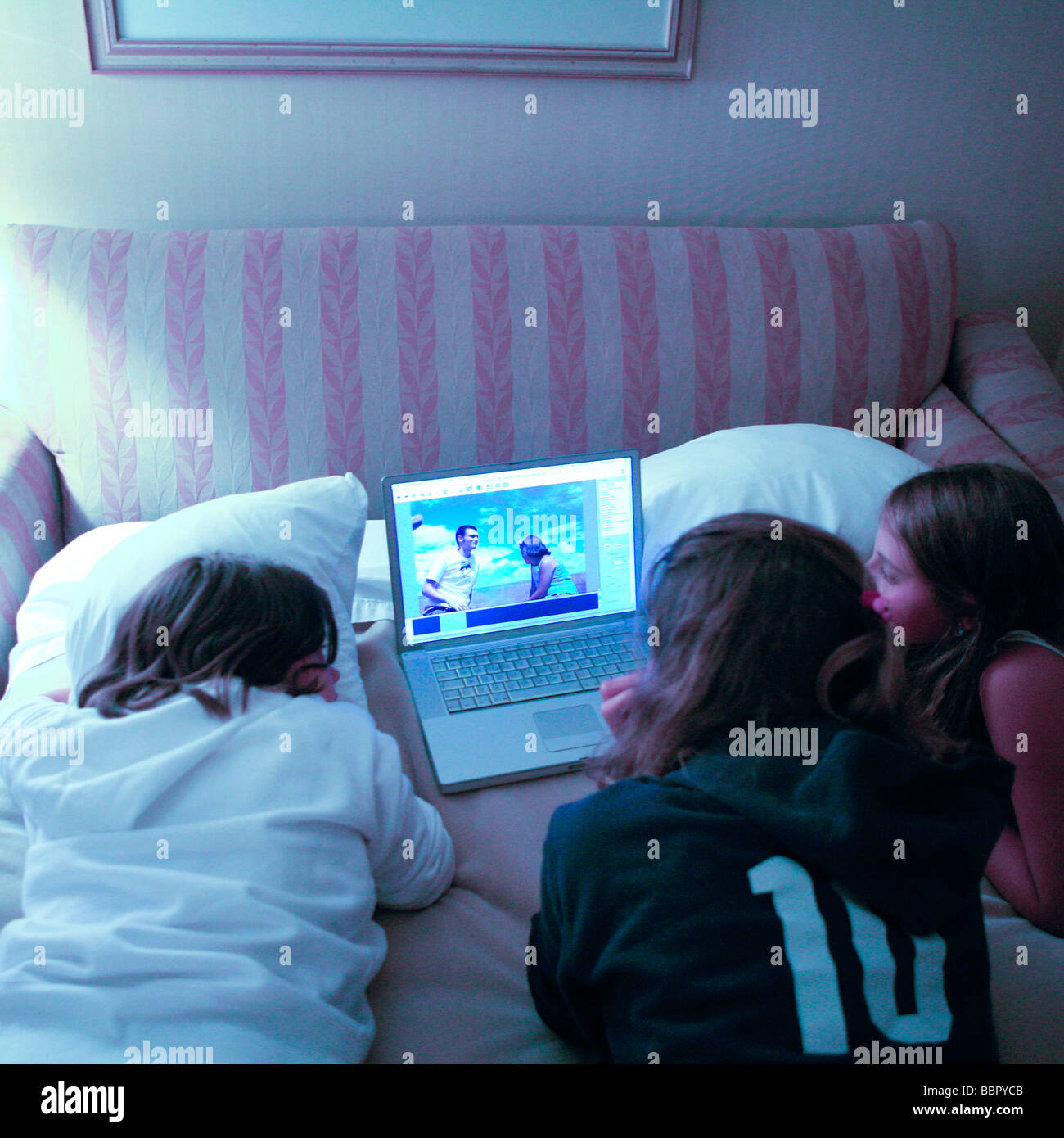 little girls with laptop on divan bed Stock Photo - Alamy