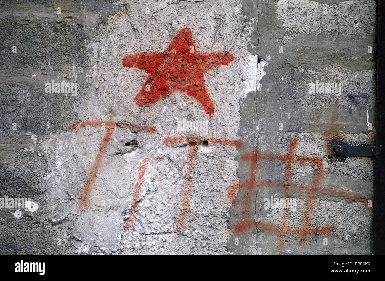 Graffiti on the wall - red star and Tito sign Stock Photo - Alamy