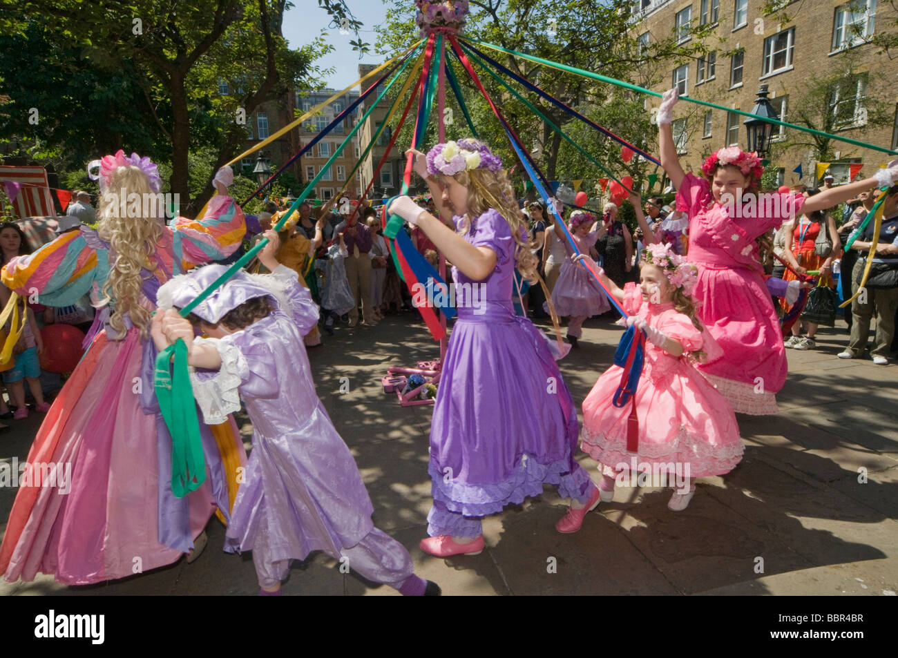Donna Maria's Maypole dancers go around the maypole in brightly colored ...