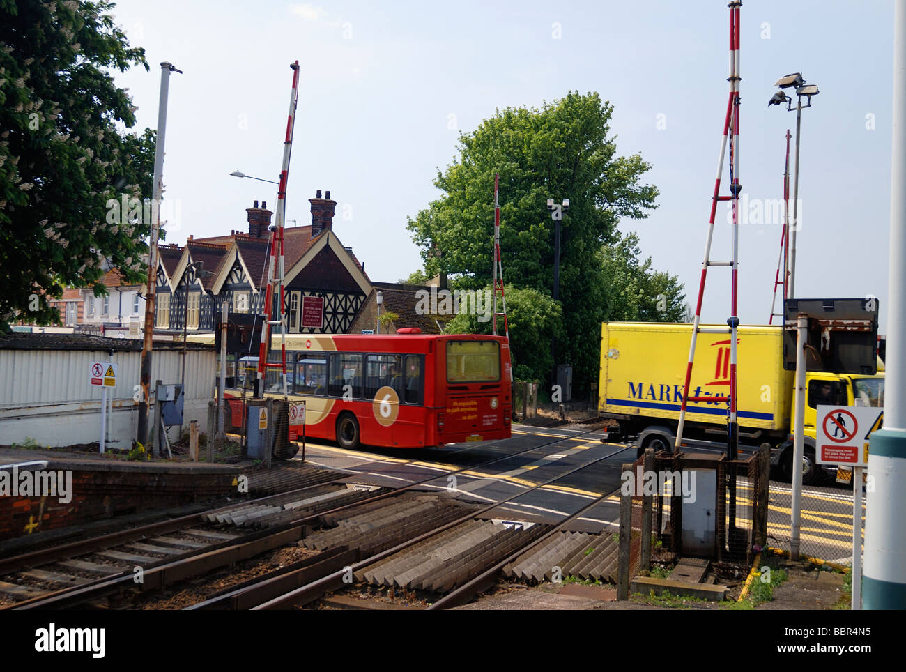 Vehicles crossing a level crossing Stock Photo - Alamy