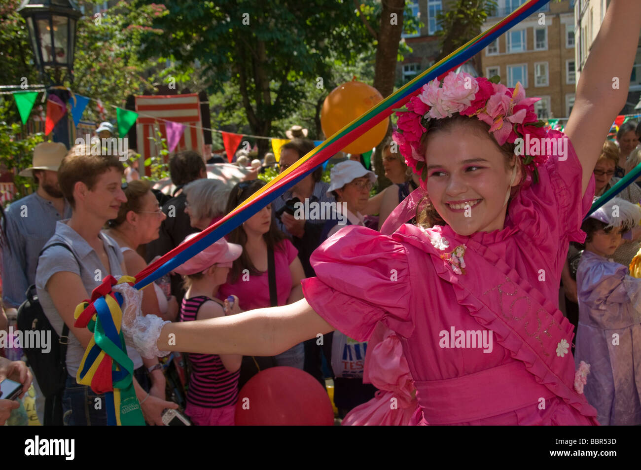 One of Donna Maria's Maypole dancers going around the maypole in a ...