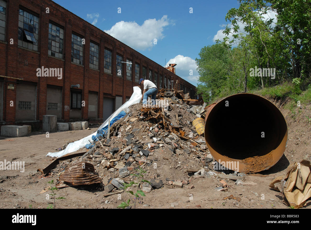 A man covers debris from a building containing asbestos in New Haven ...