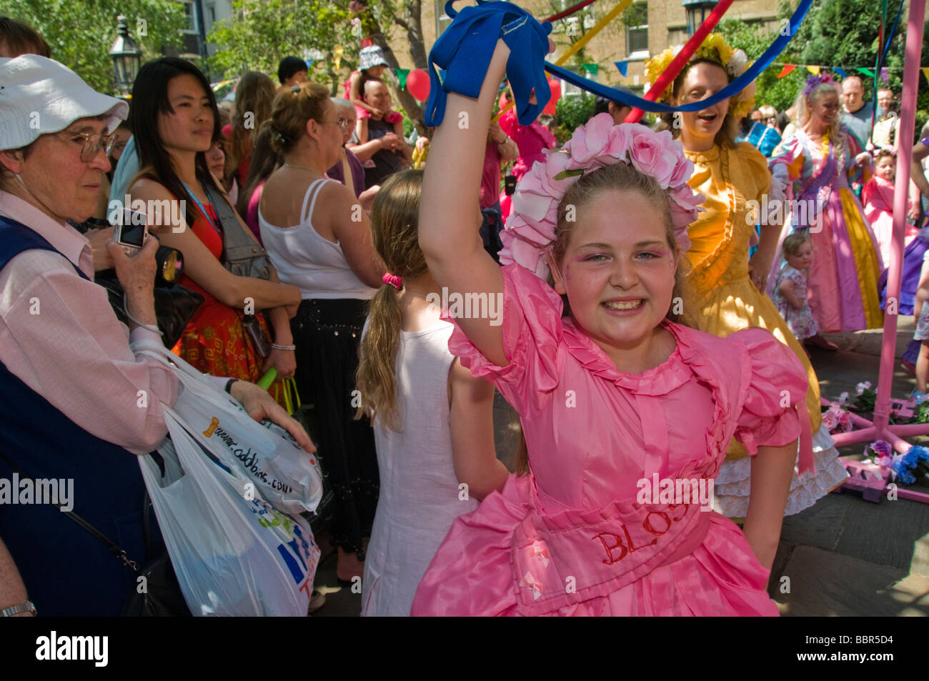 One of Donna Maria's Maypole in a bright pink dress dancing round the ...