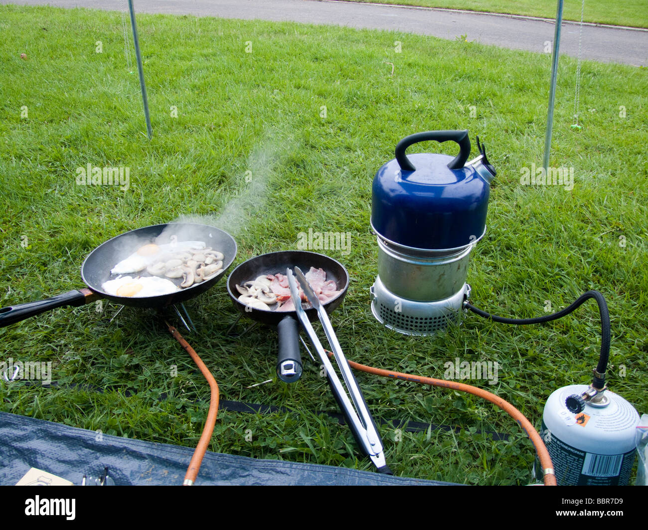Open air cooking, making breakfast while camping in a tent Stock Photo ...