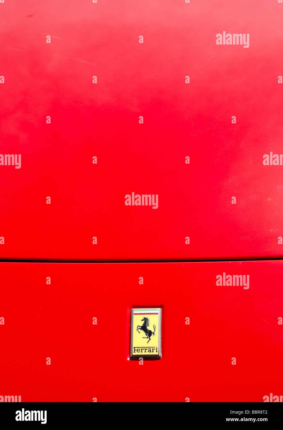 A Ferrari badge on a Red Ferrari bonnet Stock Photo - Alamy