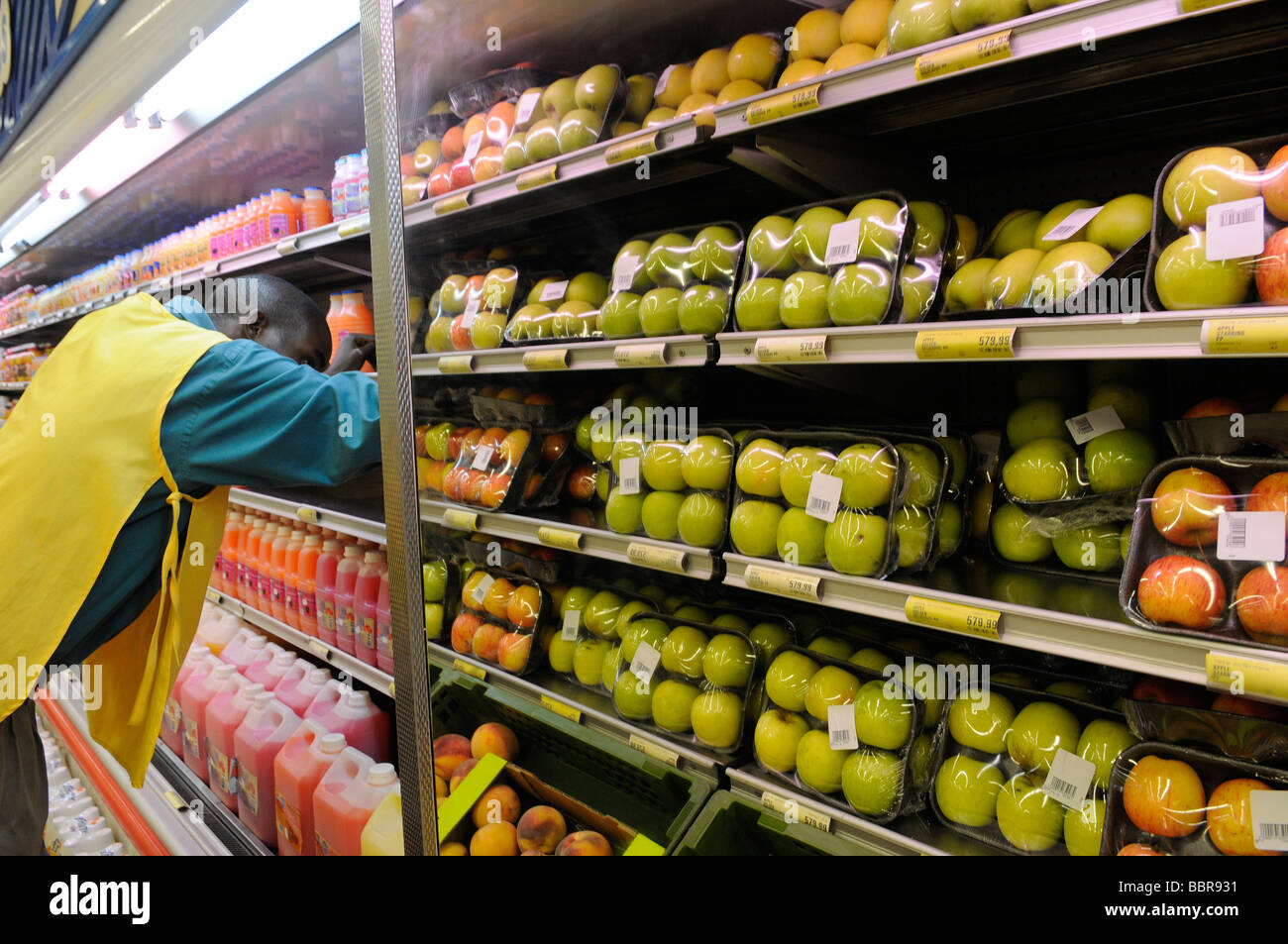 Worker stocking shelves in a supermarket, Lilongwe capital of Malawi ...