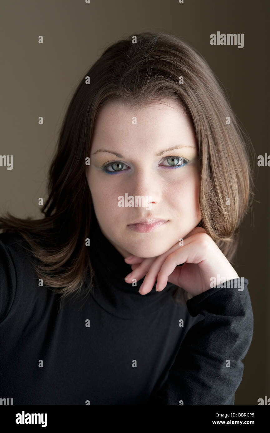 Portrait of teenager in black sweater serious look toward camera with ...