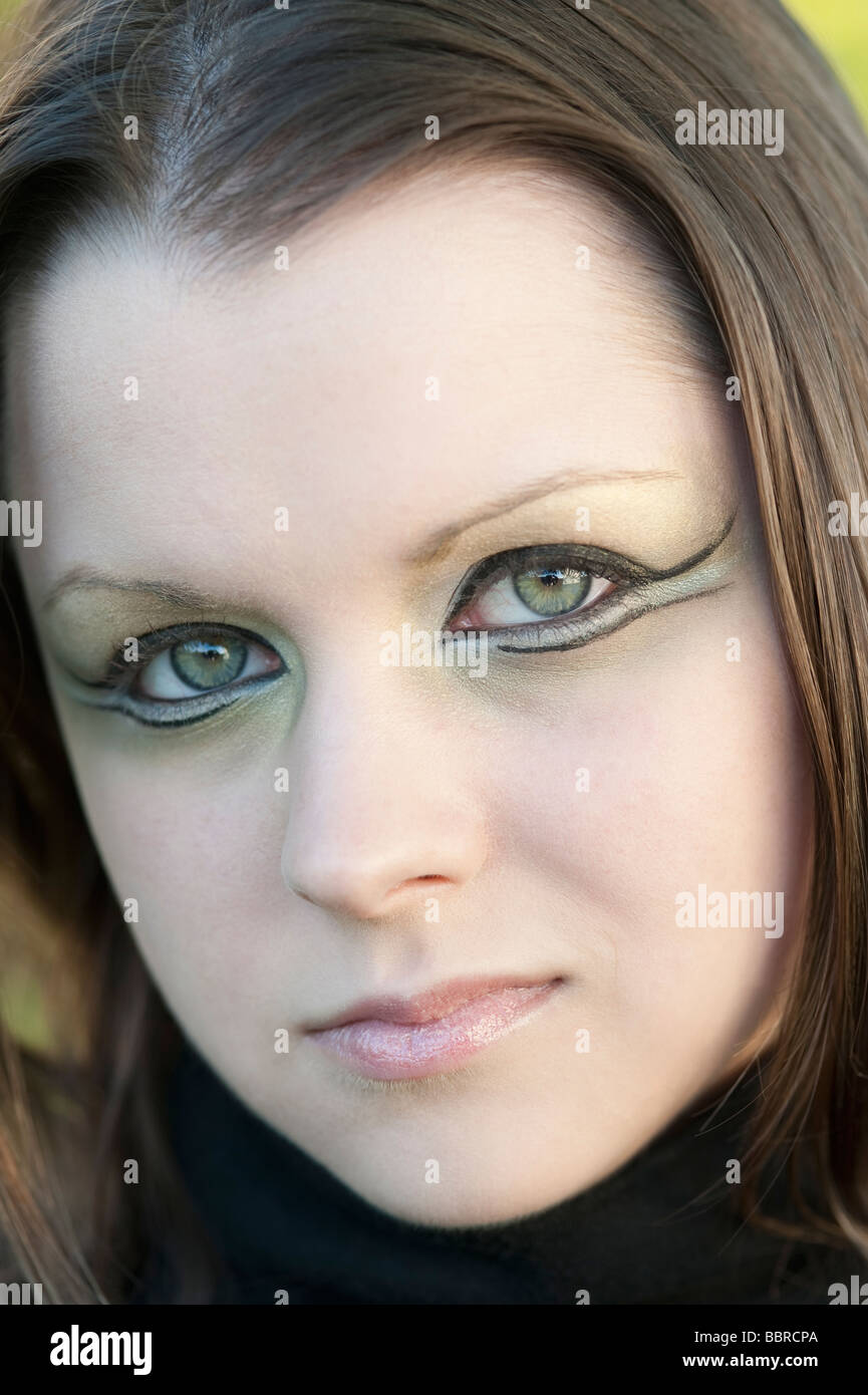 Portrait of teenager in black sweater outdoors with serious look toward ...