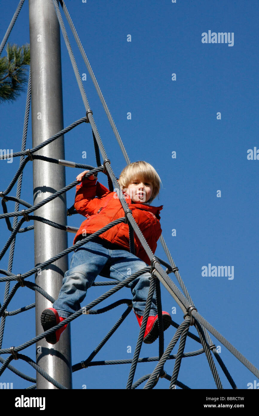 CLIMBING THE ROPES OF THE 'SPIDER'S WEB', JUNGLE GYM, CHILDREN'S ...