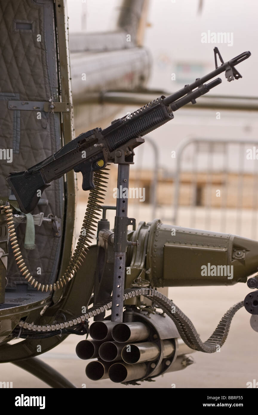 A machine gun and shells mounted on the side of an Iroquis "Huey ...