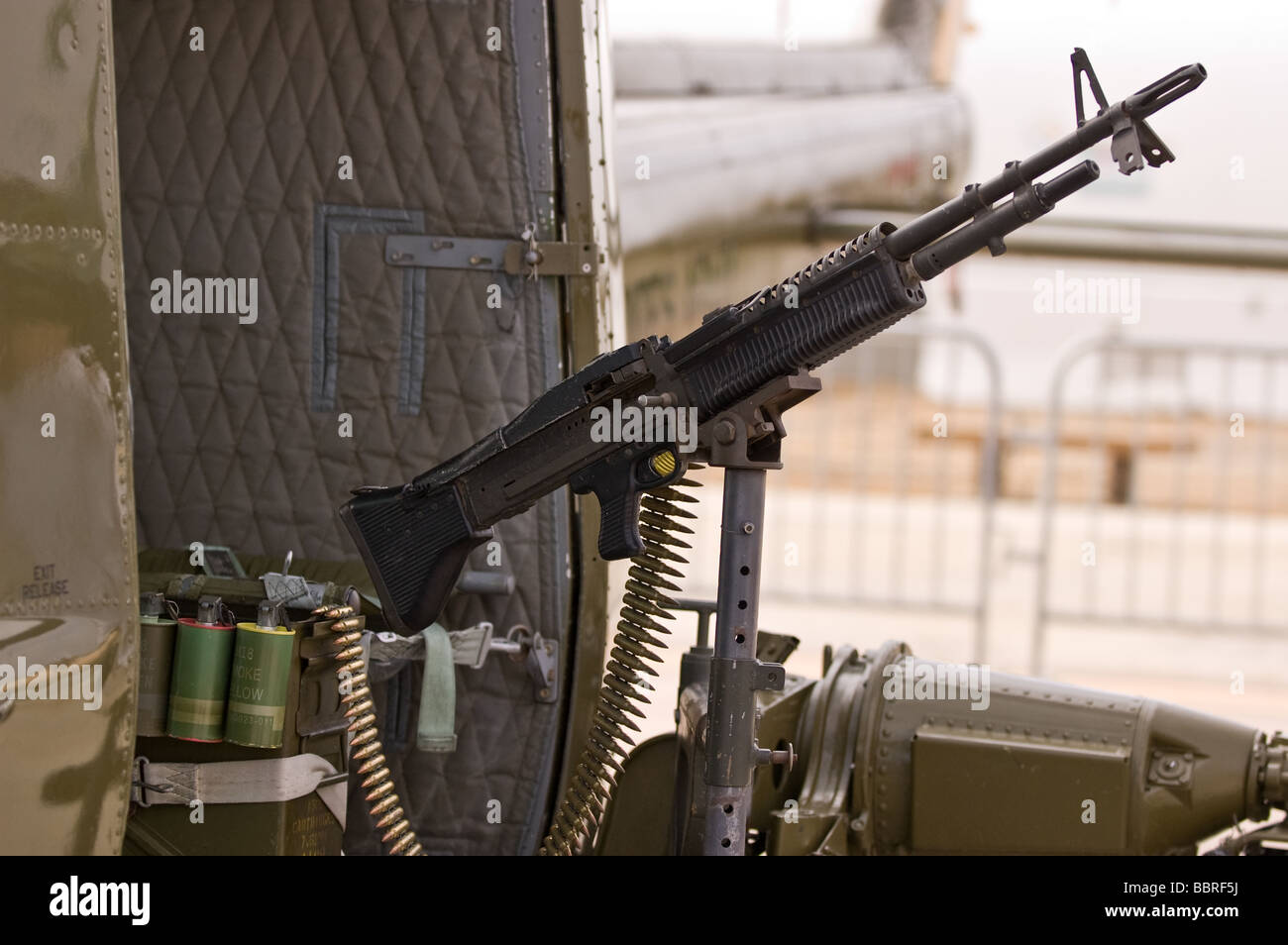 A machine gun with bullets pointing out the door of an Iroquois "Huey" Helicopter Stock Photo ...