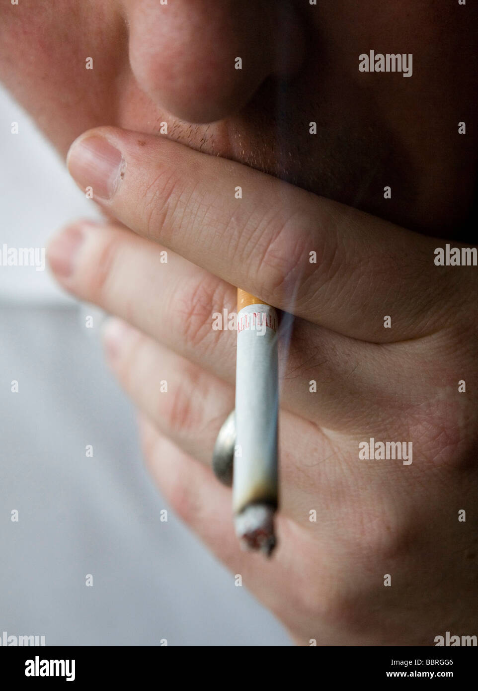 A smoker smokes a Pall Mall cigarette made by British American Tobacco ...