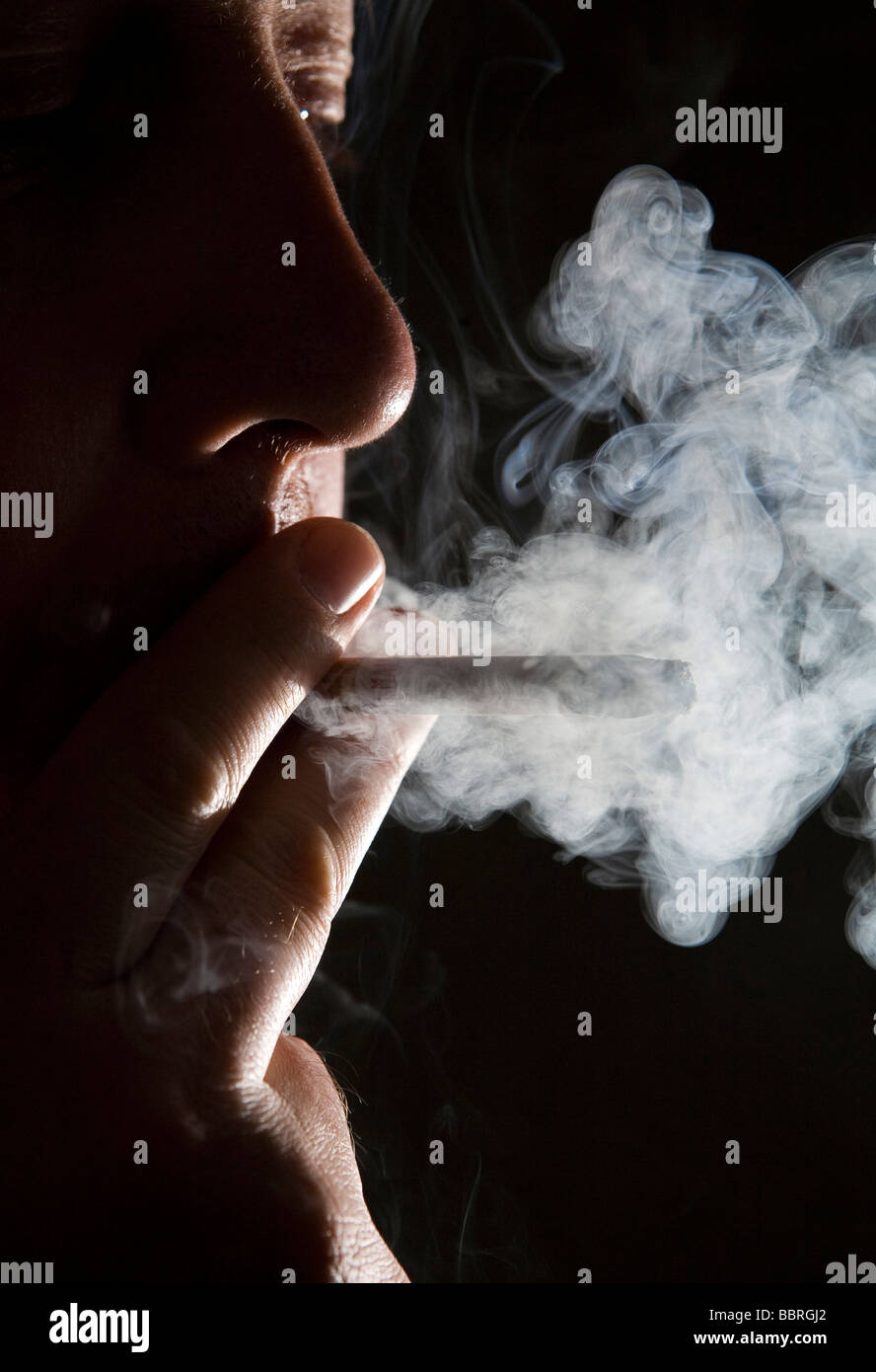 A smoker smokes a Pall Mall cigarette made by British American Tobacco ...