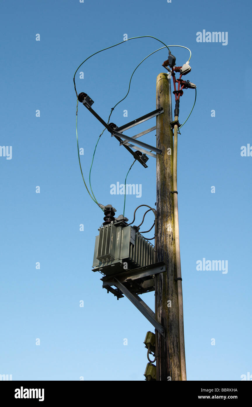 A wooden pole with power line and transformer on top Stock Photo - Alamy