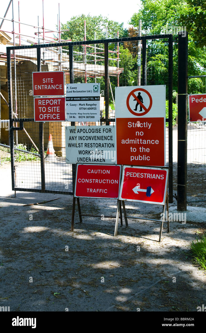 Warning signs outside a building site, Roberts Park, Saltaire, West ...