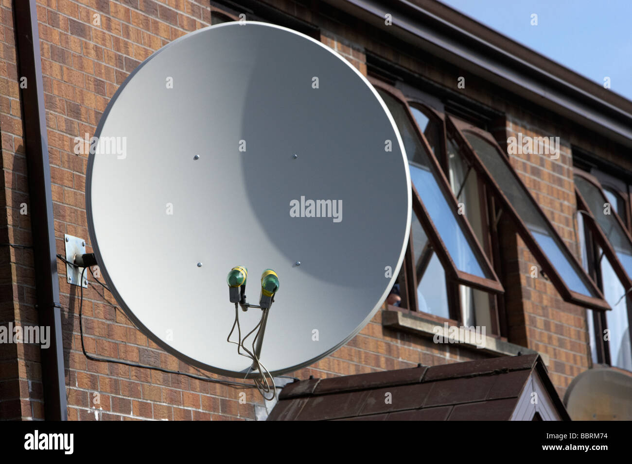 large satellite dish attached to the outside of a row of houses in the ...