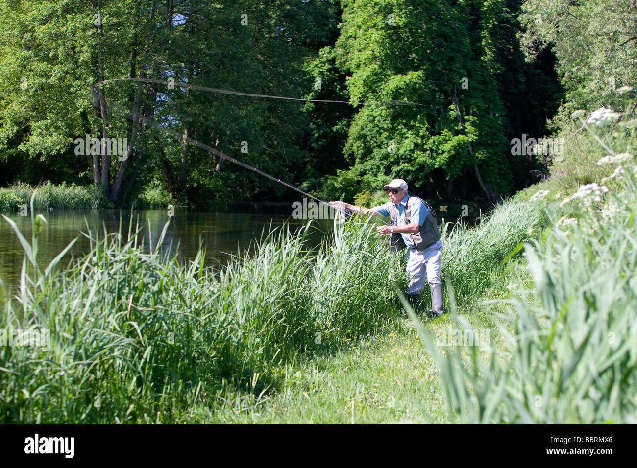 Fly fisherman casting line Stock Photo - Alamy