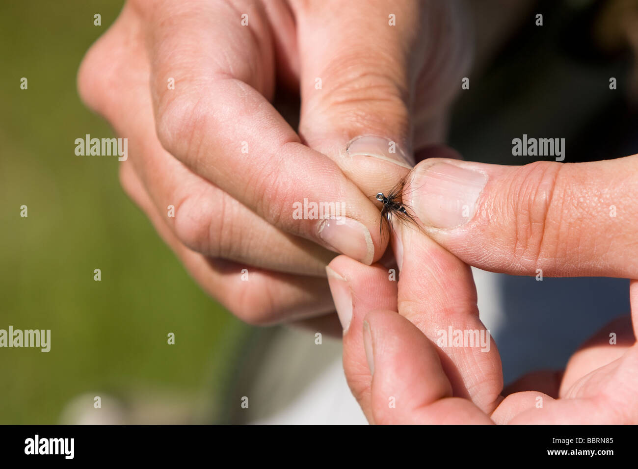 Hands tying hook hi-res stock photography and images - Alamy