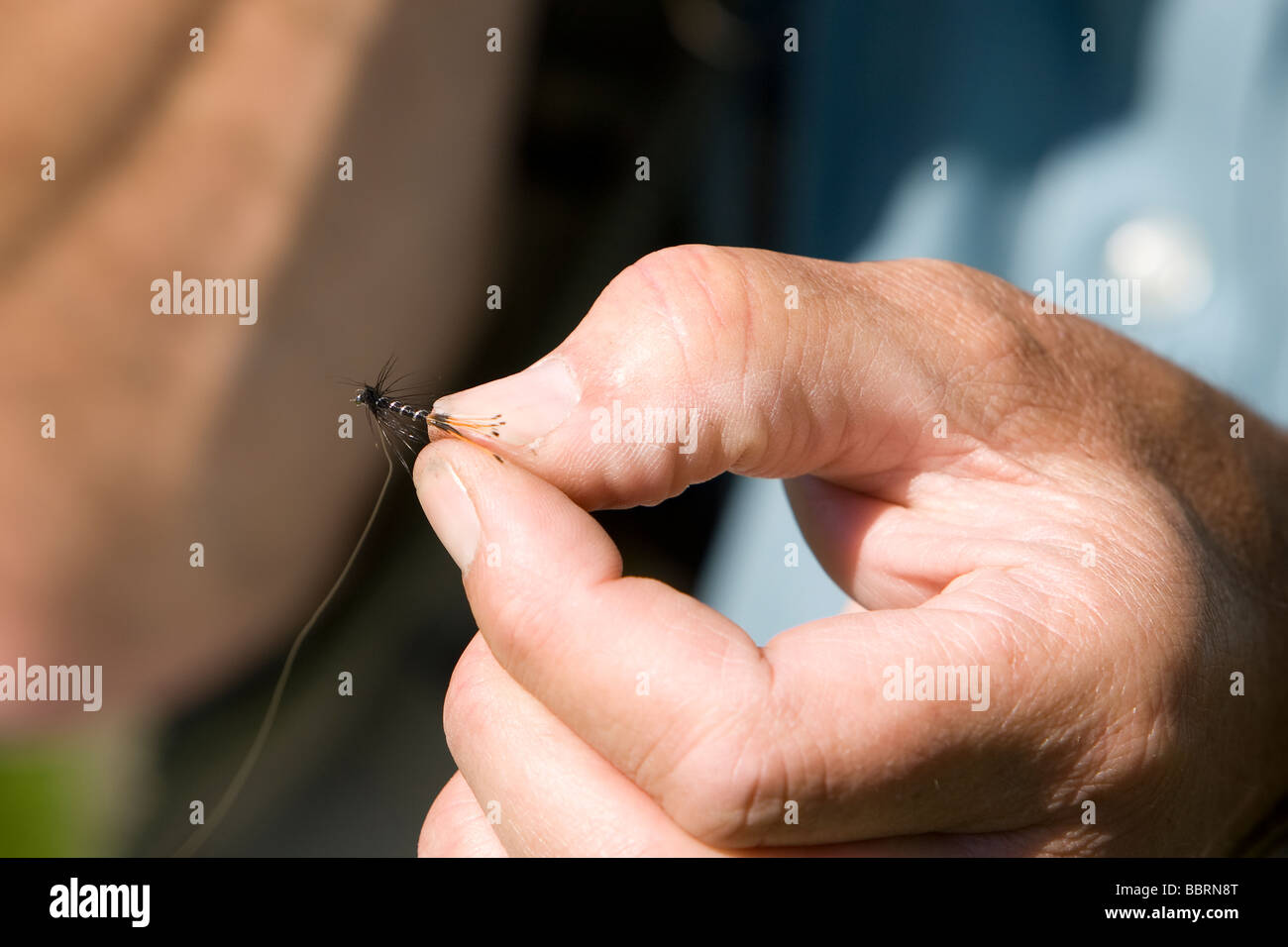 Hands tying hook hi-res stock photography and images - Alamy