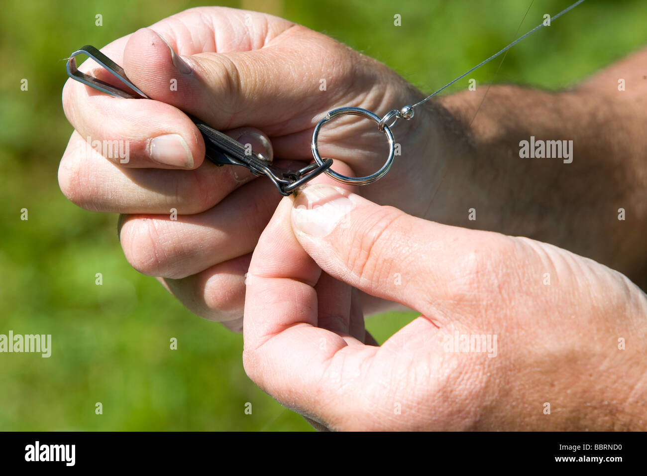 Hands tying hook hi-res stock photography and images - Alamy