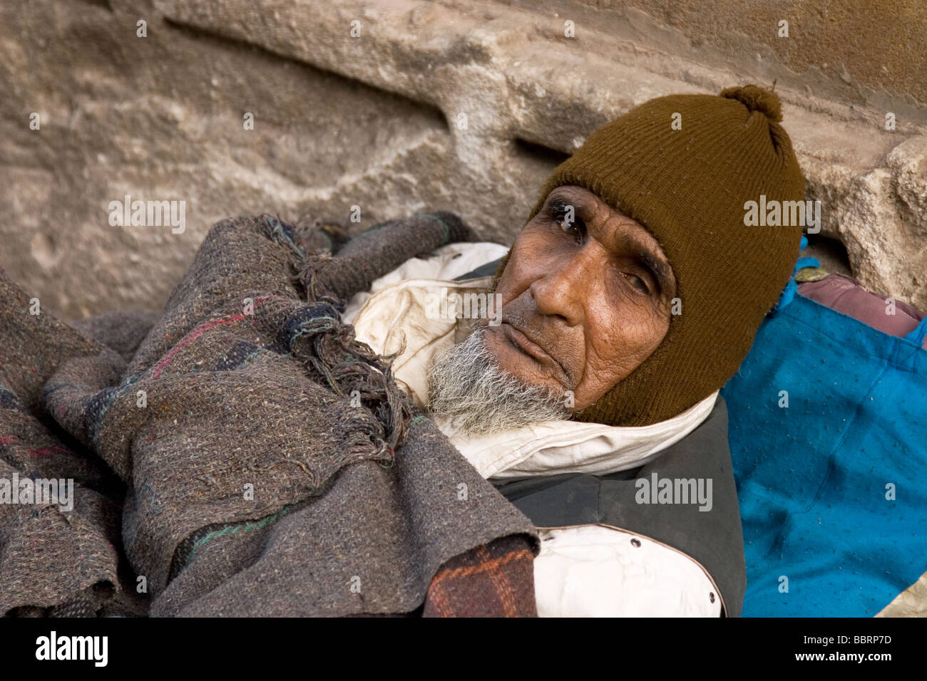 A Homeless man lies in street covered with blanket, Ahmedabad City ...