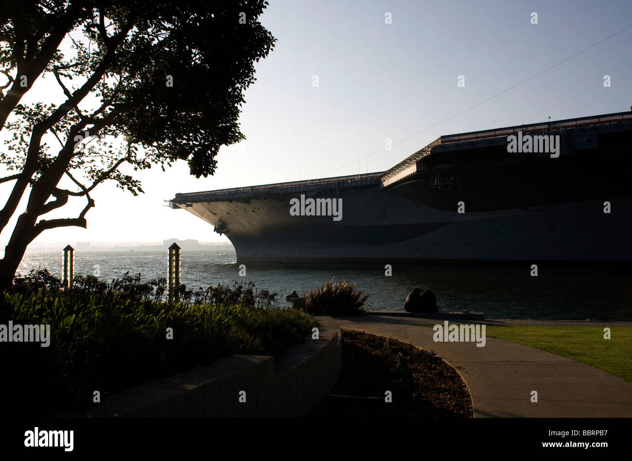 A couple relaxing close to USS Midway, now a floating naval museum in ...
