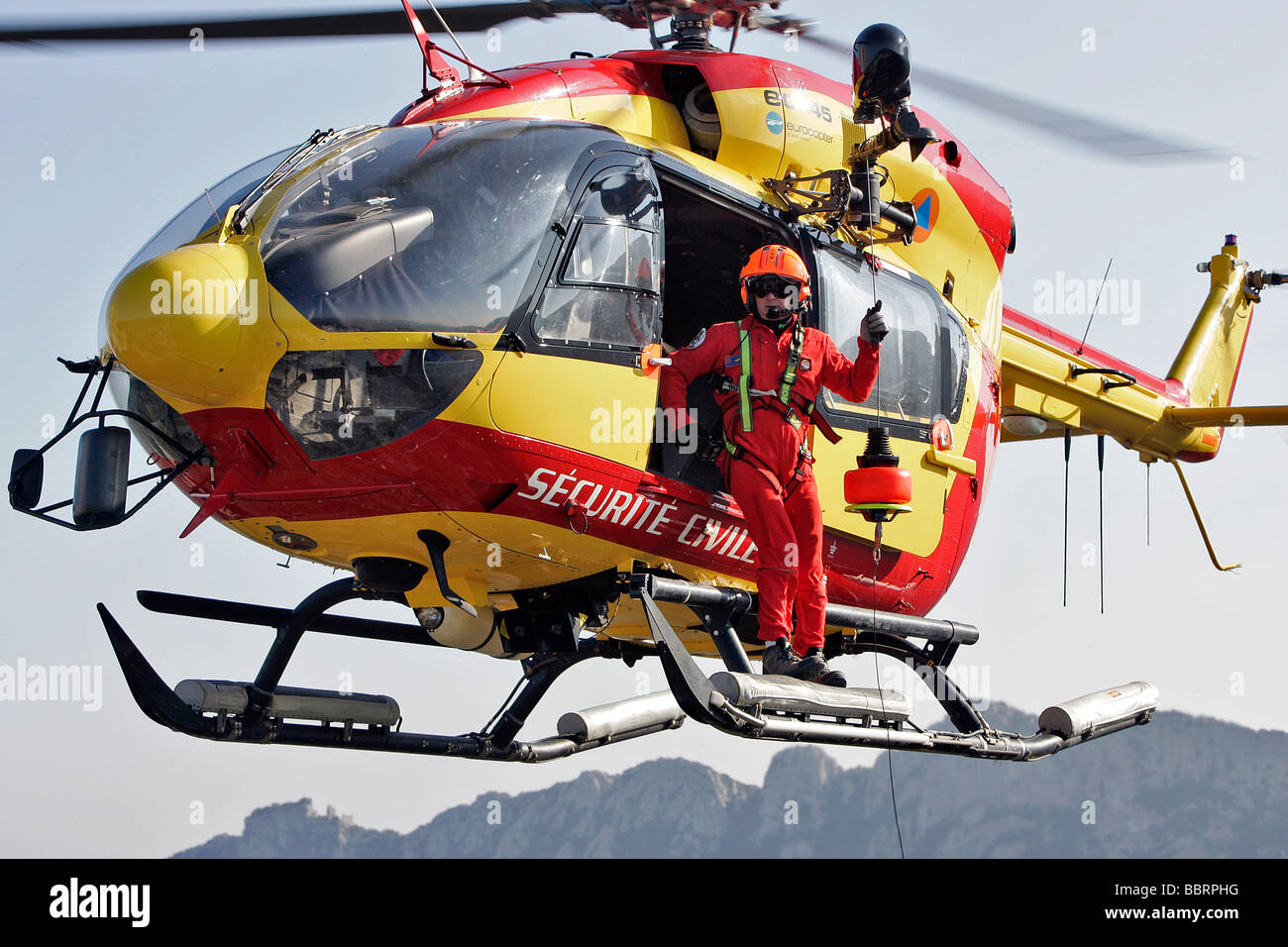 MOUNTAIN RESCUE, WINCHING UP INTO THE EC145 HELICOPTER, MASSIF DU PIC ...