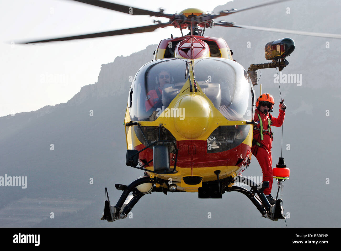 MOUNTAIN RESCUE, WINCHING UP INTO THE EC145 HELICOPTER, MASSIF DU PIC ...