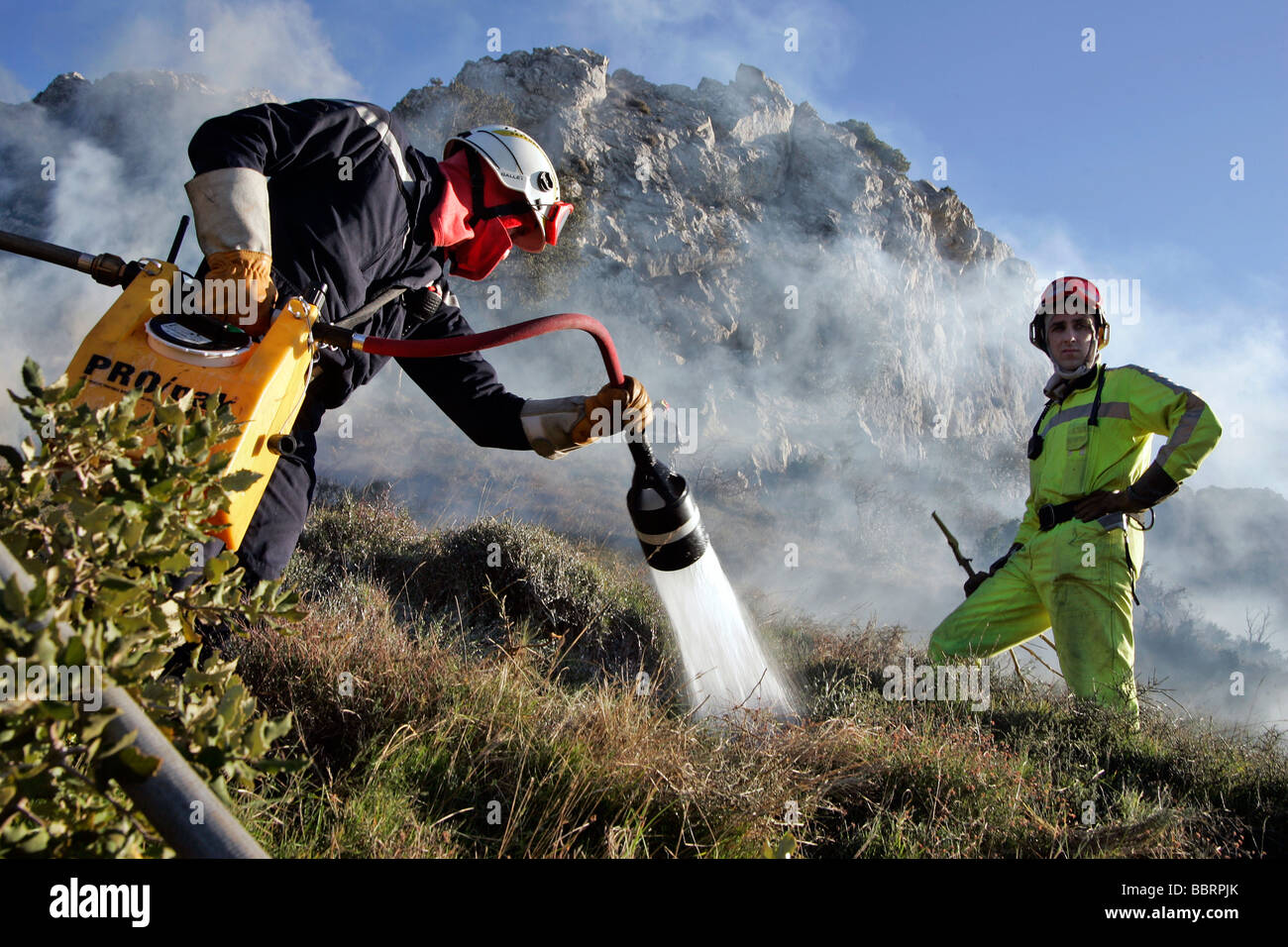 Fireman beating fire hi-res stock photography and images - Alamy