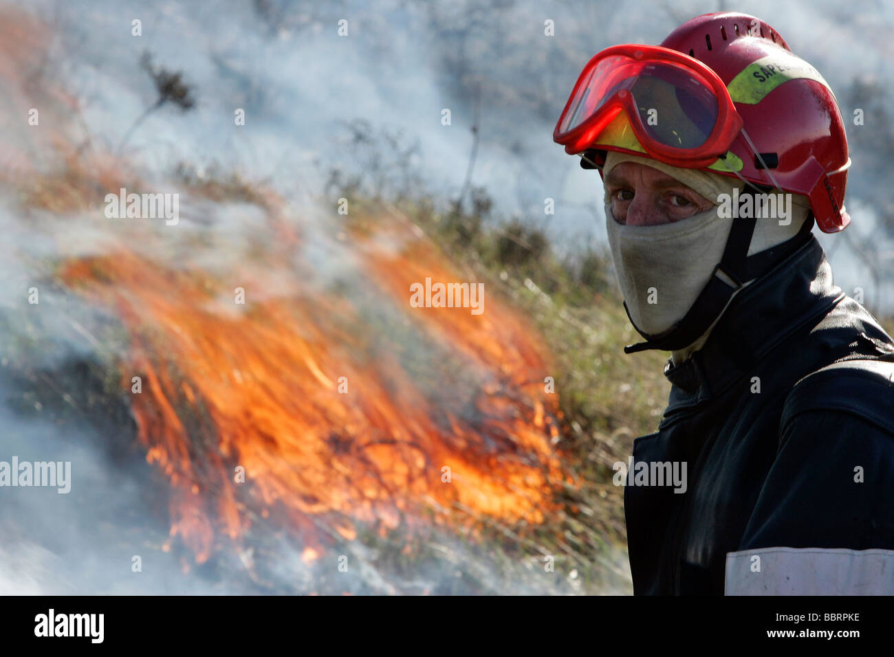 Fireman beating fire hi-res stock photography and images - Alamy
