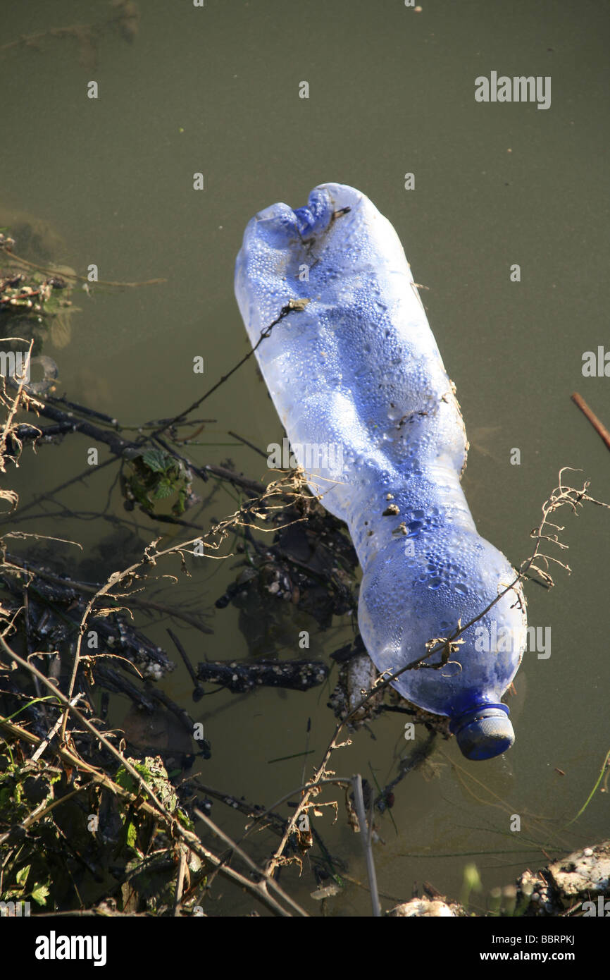 one single plastic water bottle floating in river Stock Photo - Alamy