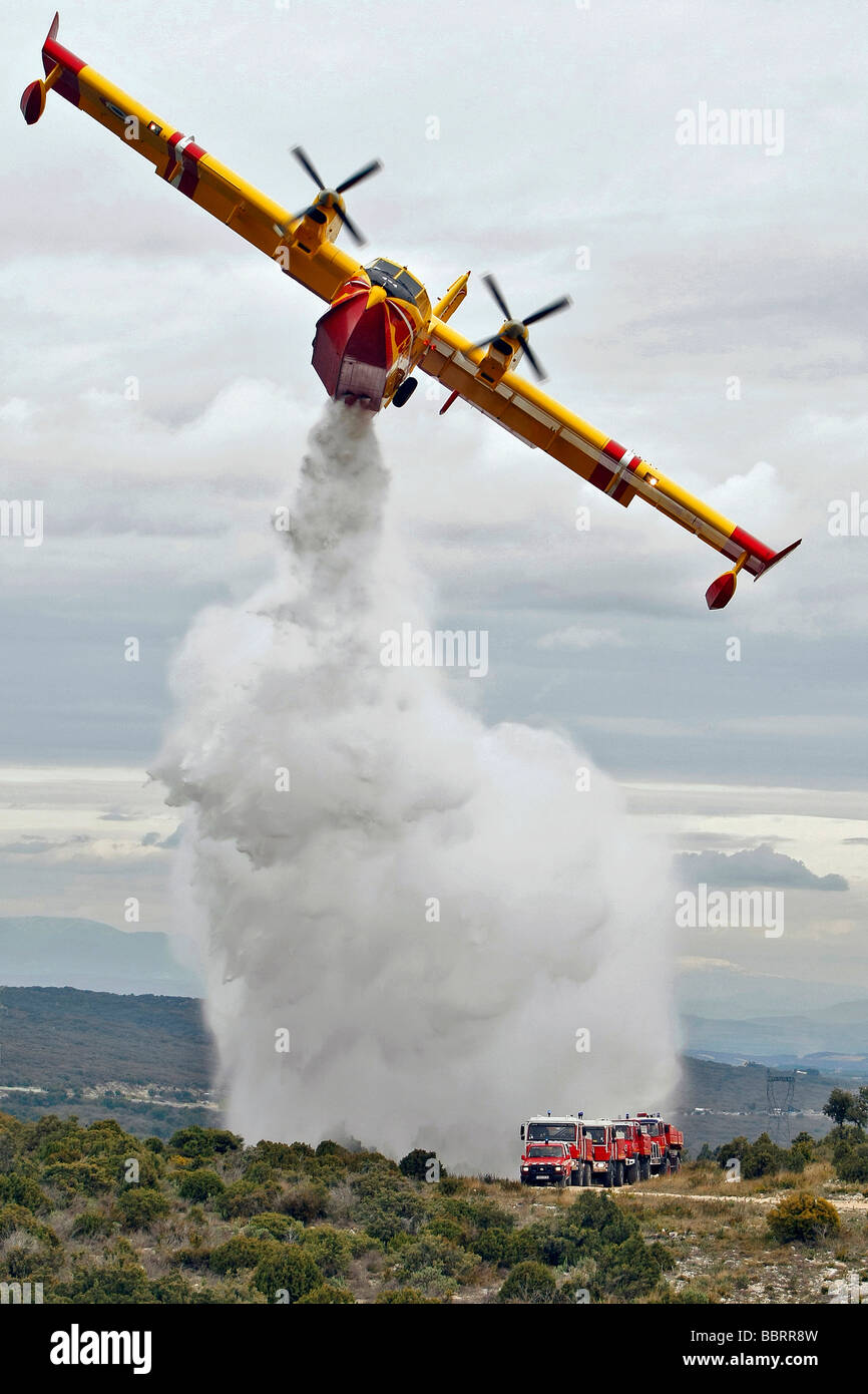 CANADAIR CL 415 PELICAN DROPPING THE WATER FROM ITS HOLD AS PROTECTION ...