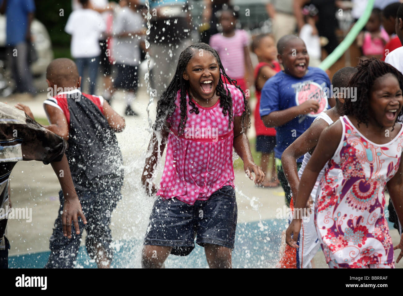 Children play in a public "splash Pad" "Water Park" in New Haven CT USA ...