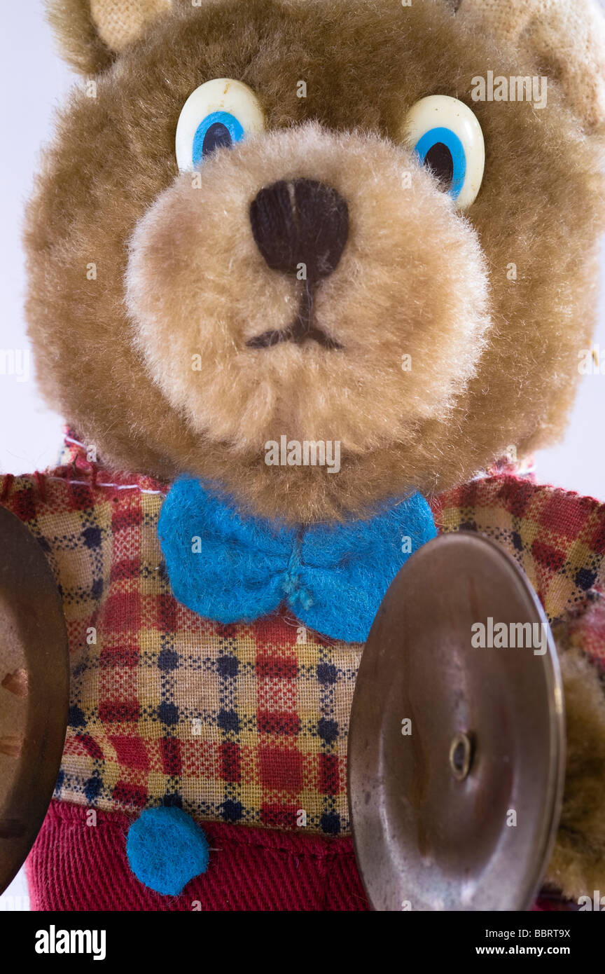 Wind up teddy bear with brass cymbals isolated against a white ...