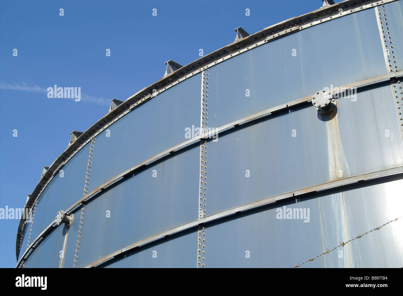 Rusty industrial storage tank with a valve against blue sky Stock Photo ...
