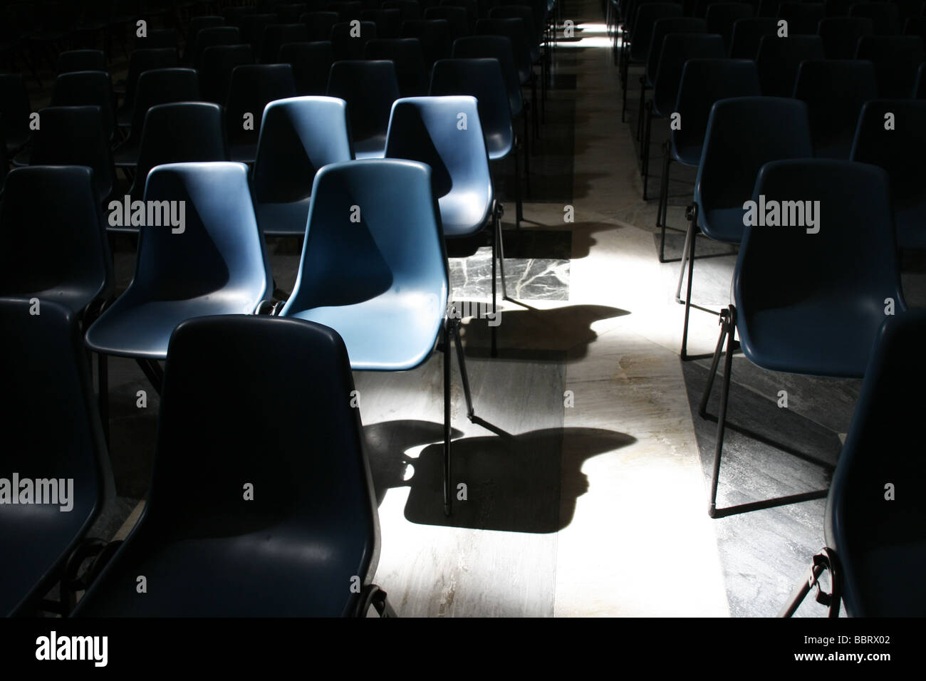 rows of empty plastic chairs in church in rome italy Stock Photo - Alamy