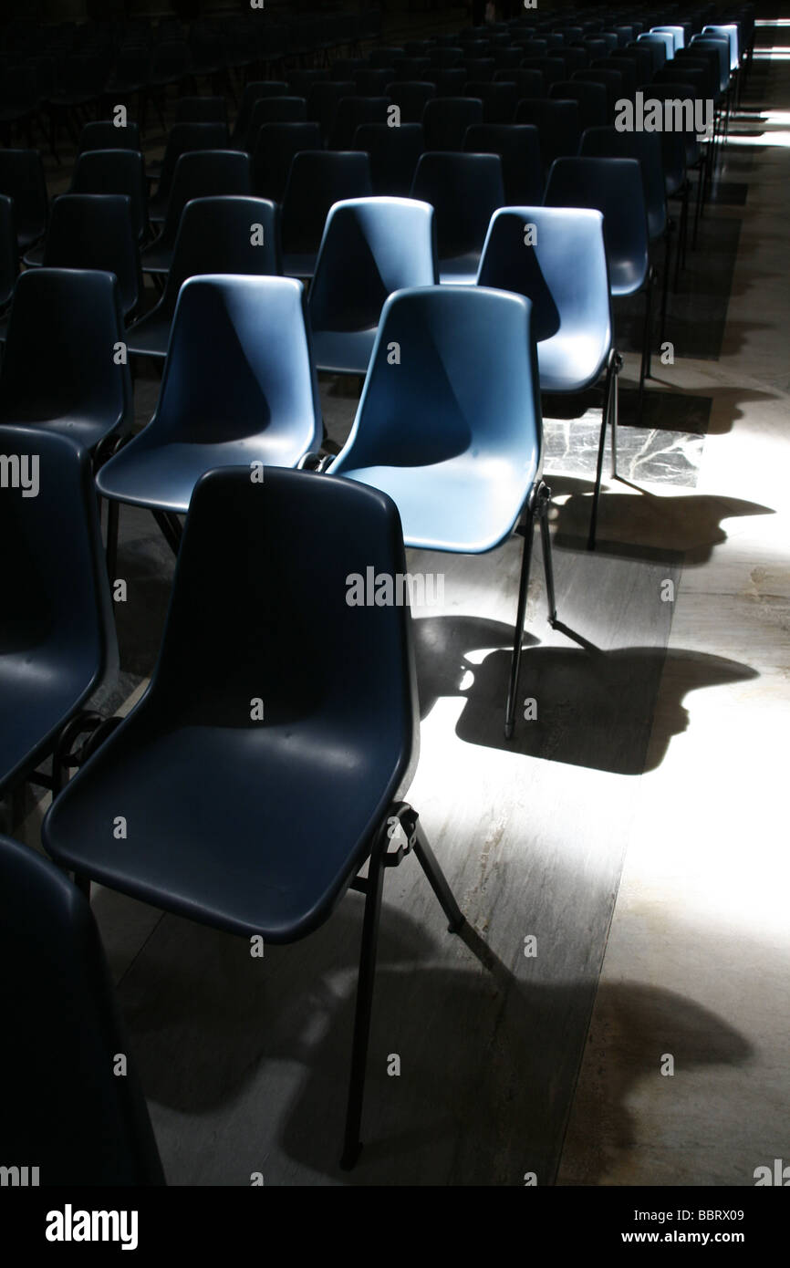 rows of empty plastic chairs in church in rome italy Stock Photo - Alamy