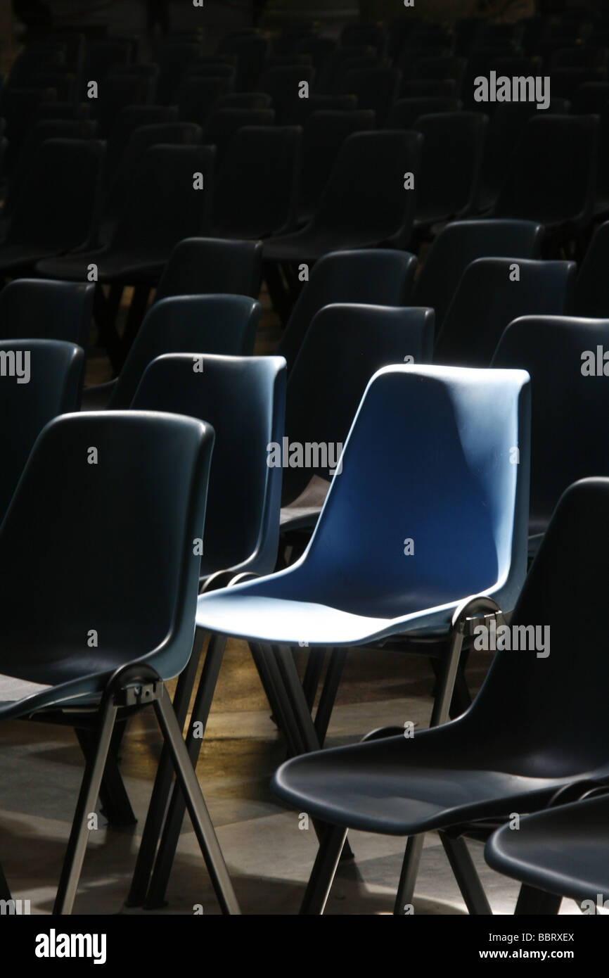 rows of empty plastic chairs in church in rome italy Stock Photo - Alamy