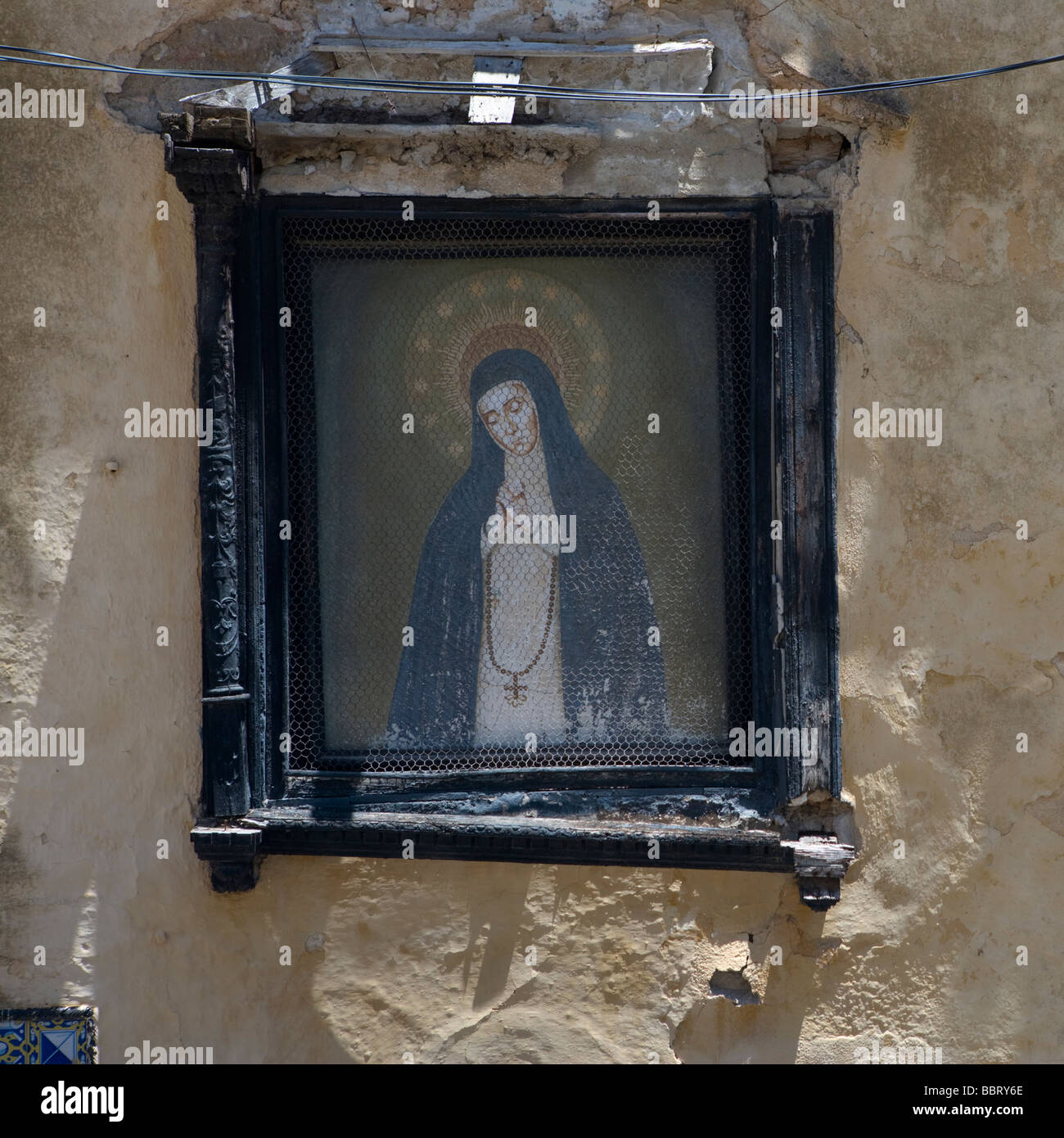 A crumbling devotional shrine in an alleway of La Ciudad old town of ...