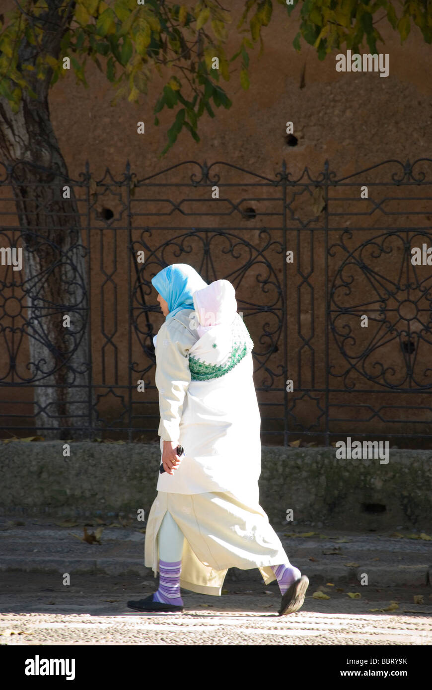 Moroccan woman carrying a baby on her back Morocco Chefchaouen Stock ...