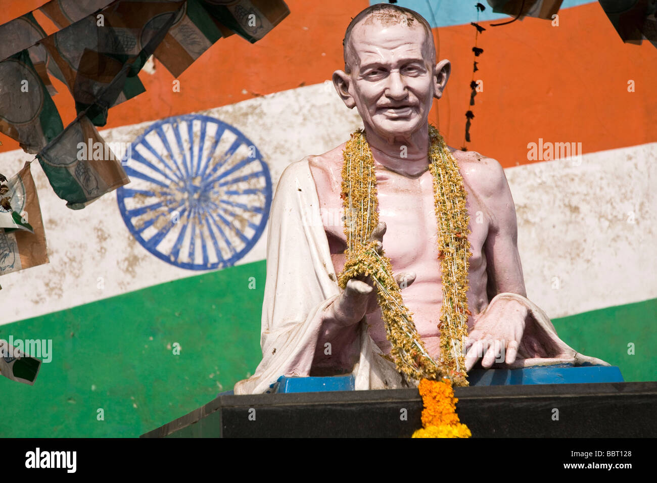 The garlanded statue of Mahatma Gandhi stands in front of the Indian ...
