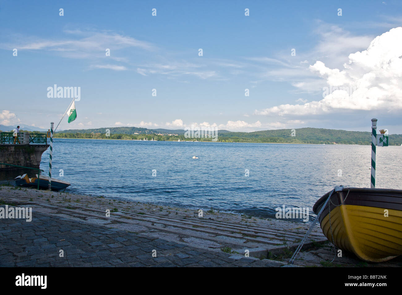 Arona lakefront with a boat and a flag Stock Photo - Alamy