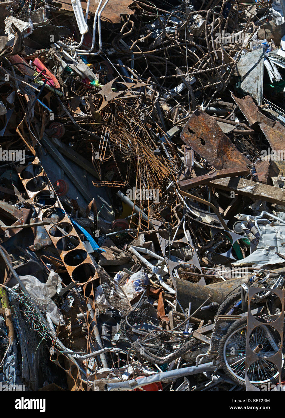 A pile of mixed scrap metals awaiting processing at a recycling centre ...