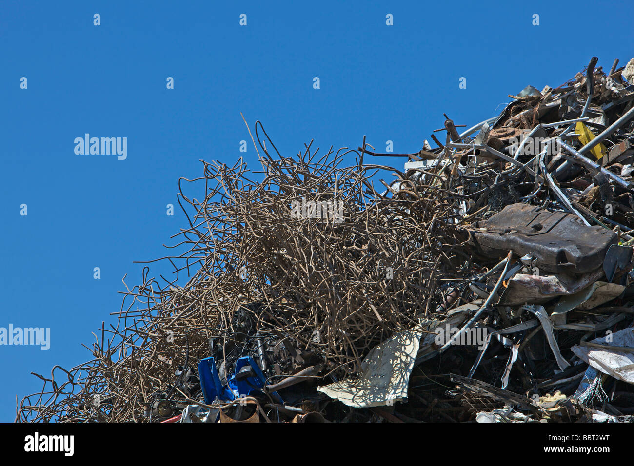 A pile of mixed scrap metals awaiting processing at a recycling centre ...