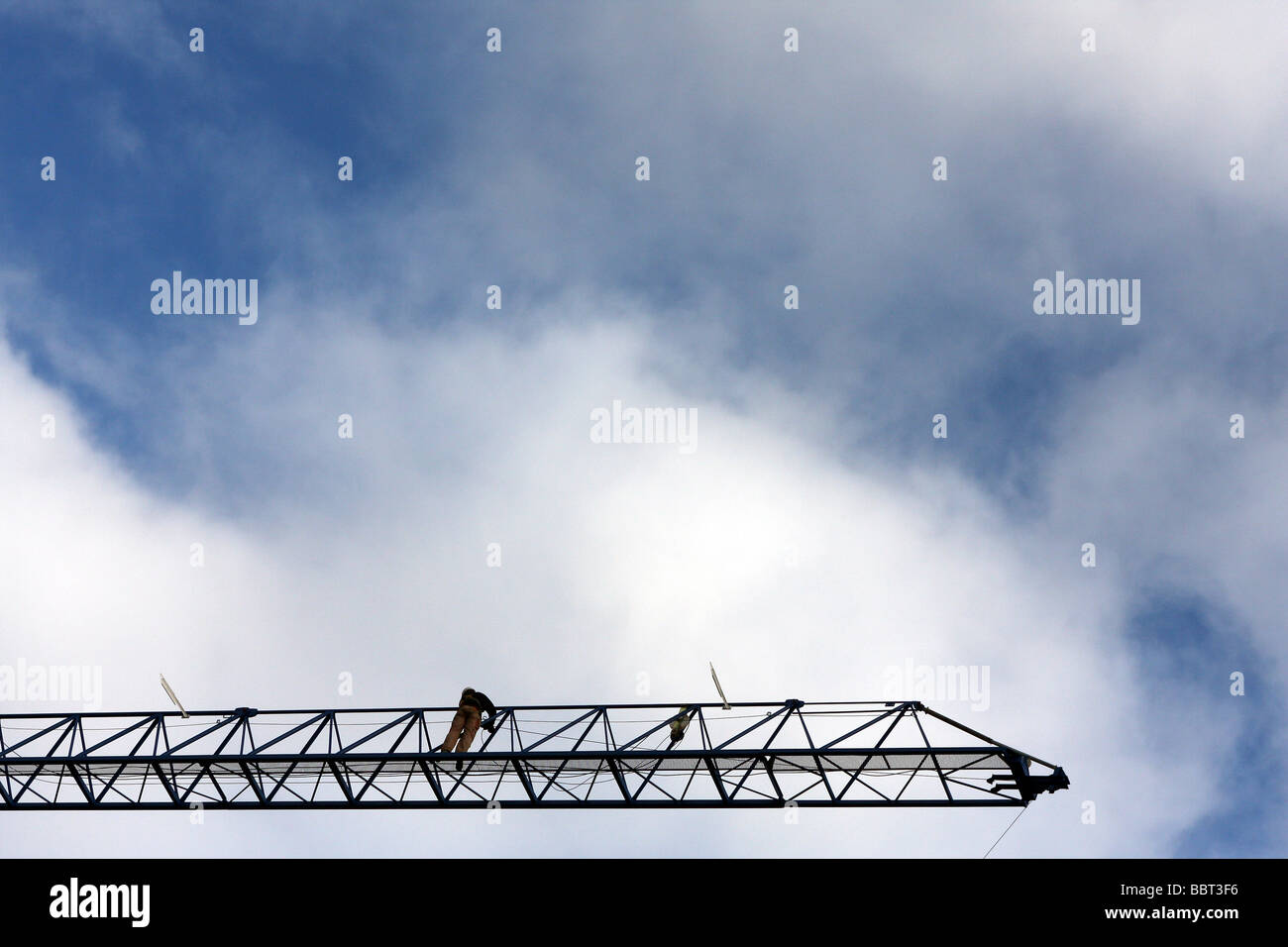 building site construction crane boom arm with the operator freeing a ...