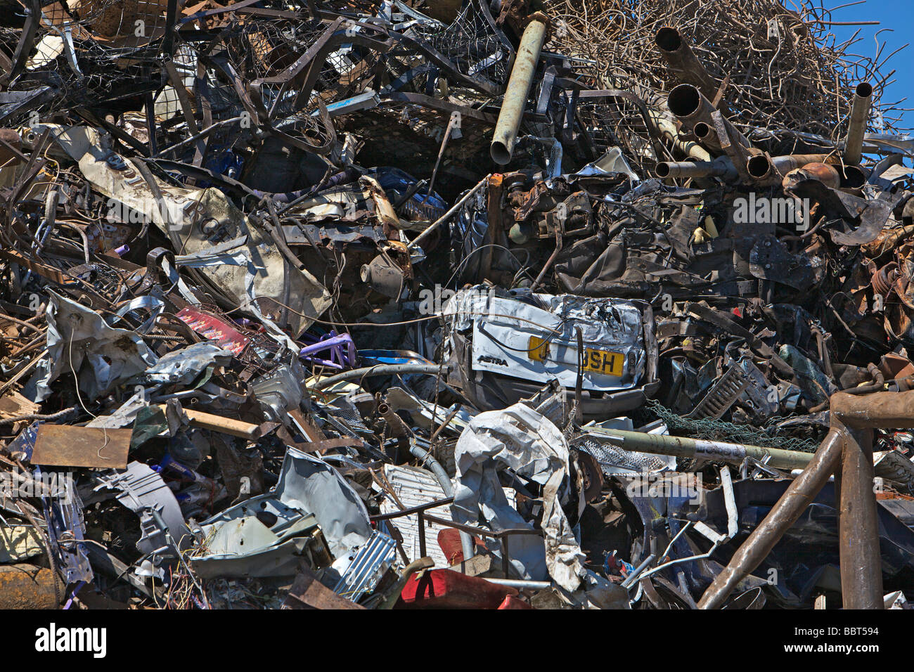 A pile of mixed scrap metals awaiting processing at a recycling centre ...