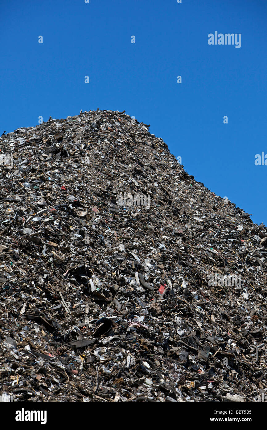 A heap of processed scrap metals at a recycling centre with deep blue ...