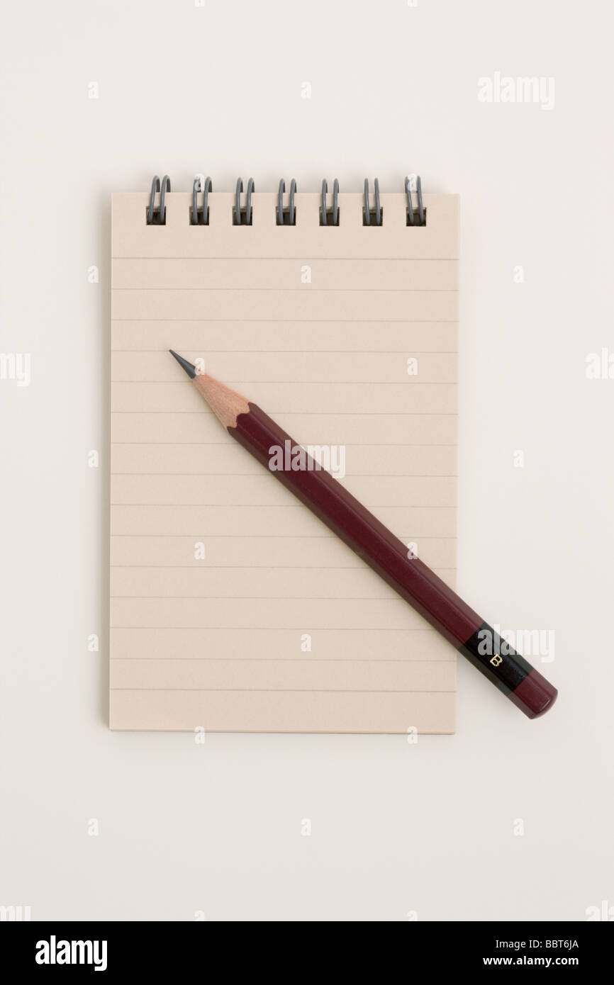 Spiral notepad with pencil Stock Photo - Alamy