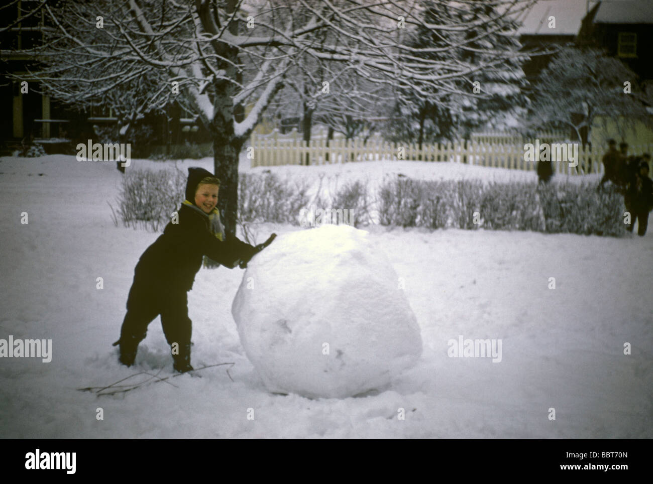 Little girl rolls a large snowball in St Lambert, Montreal 1956 Stock ...