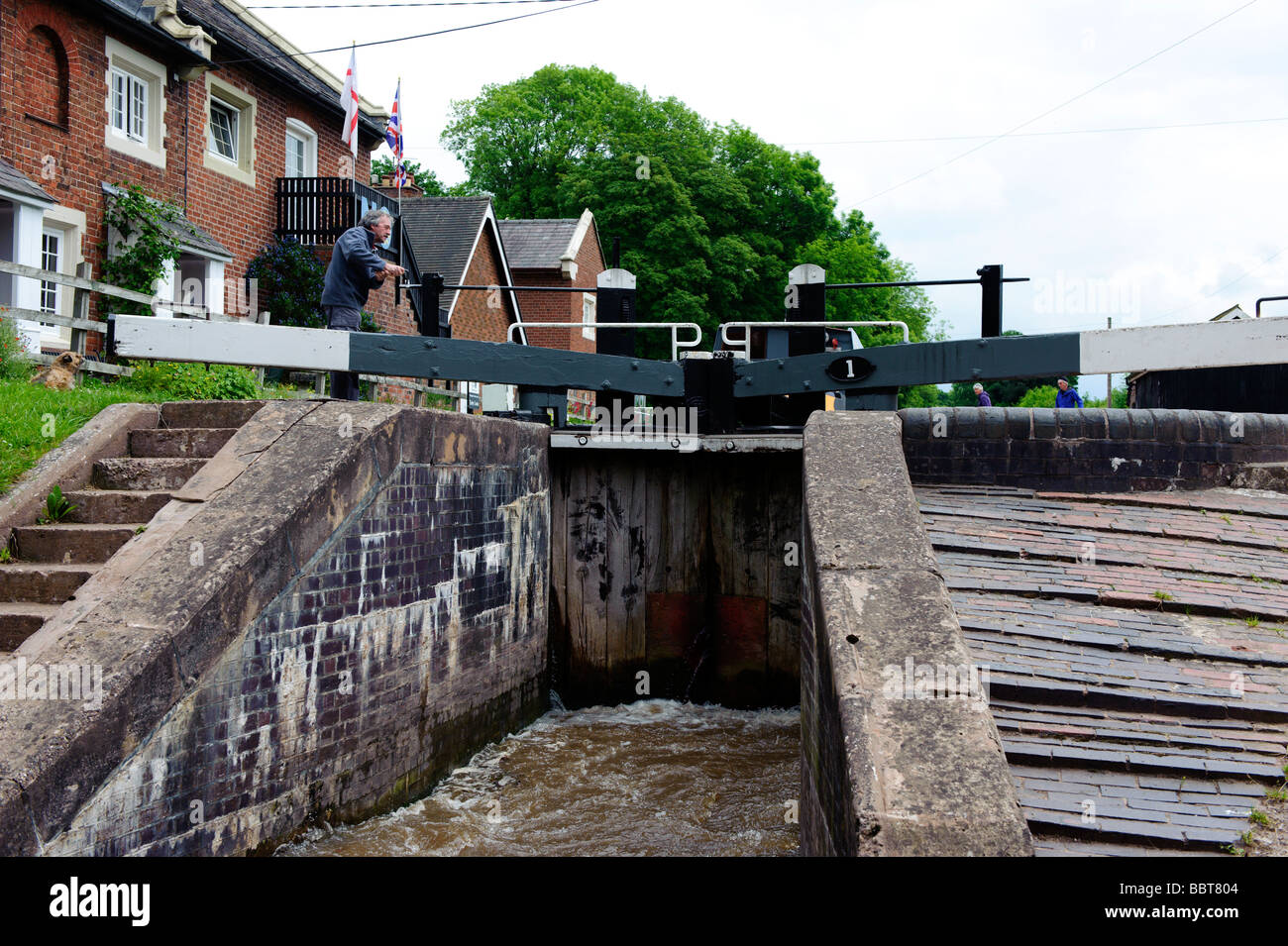 Lock keeper help the crew of a barge negotiate their way through the ...